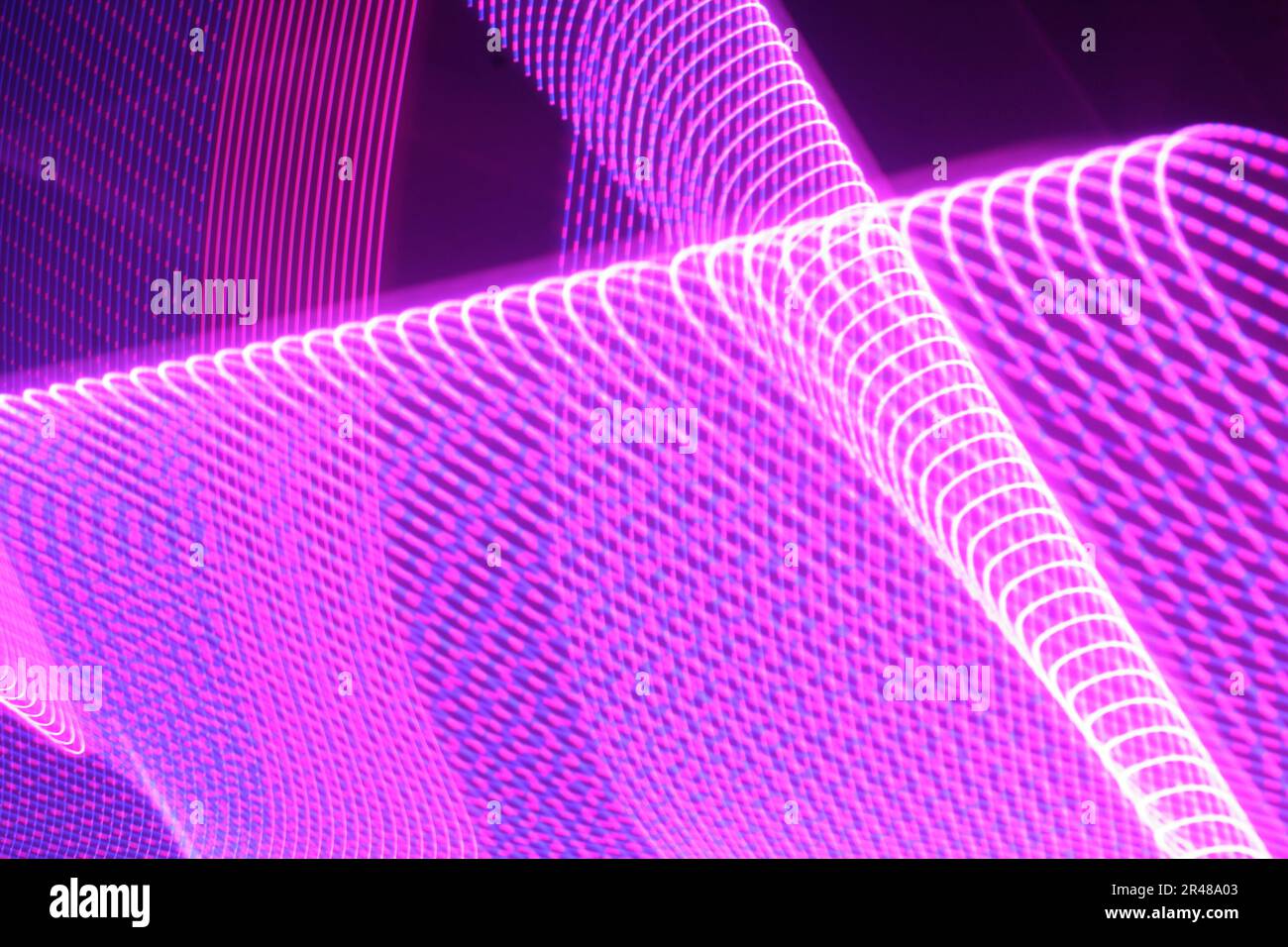 A large display featuring a pattern of pink lights radiating outward ...