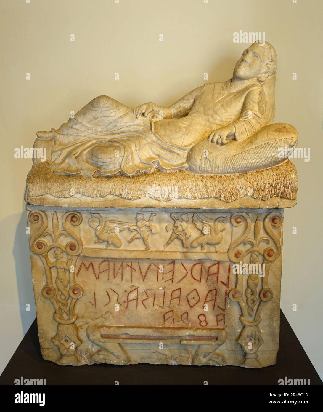 Urn with reclining male figure and kline-shaped chest with inscription ...