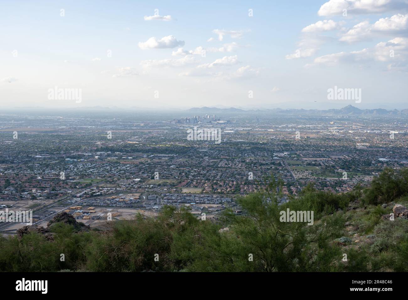 A scenic view of a town in the distance of mountains and greenery ...