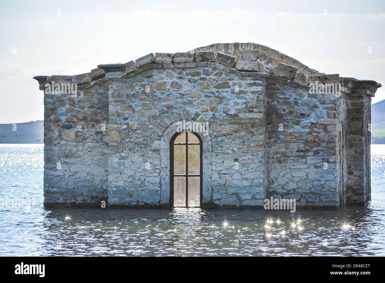 An ancient stone edifice situated in the middle of a body of water ...
