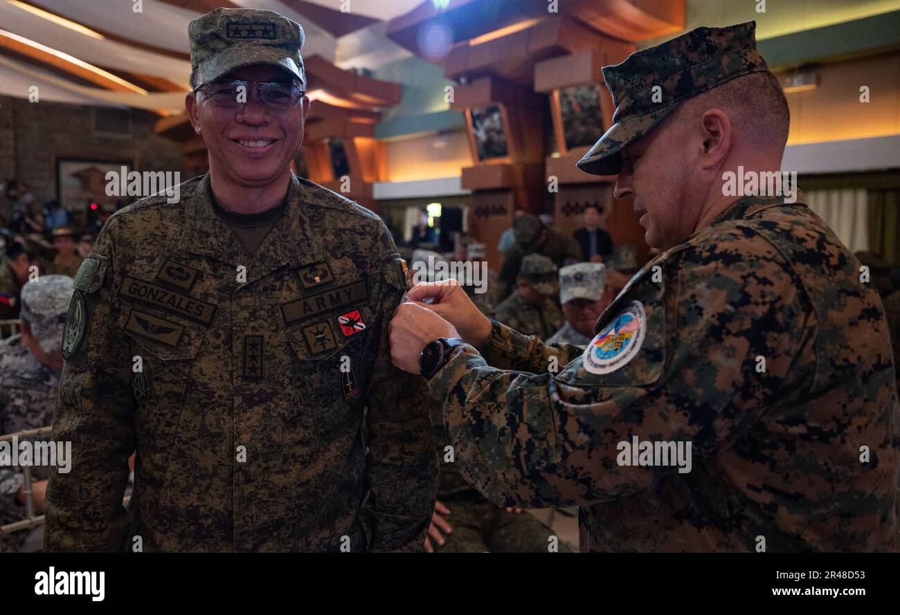 A U.S. Marine places the Balikatan 23 patch on a Philippine Marines ...