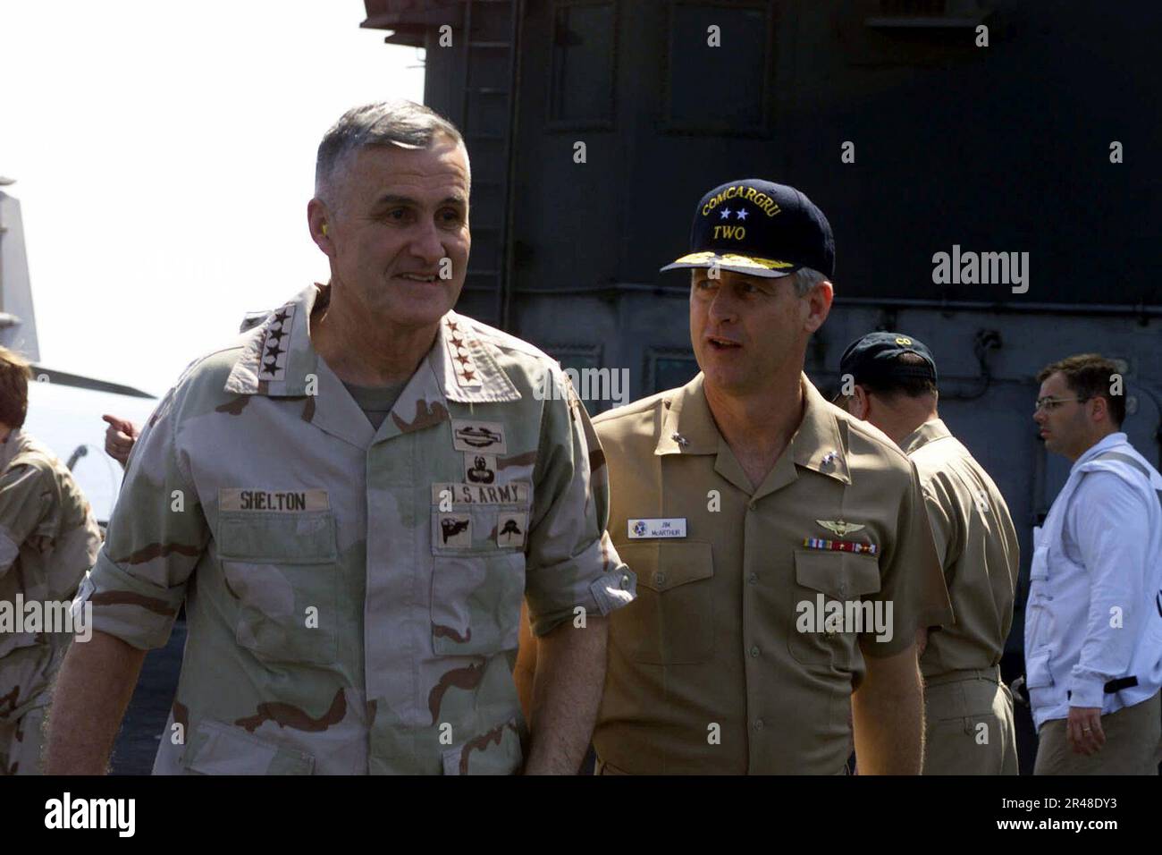 US Army Gen. Henry Shelton is greeted by US Navy Rear Adm. James McArthur shortly after his ...