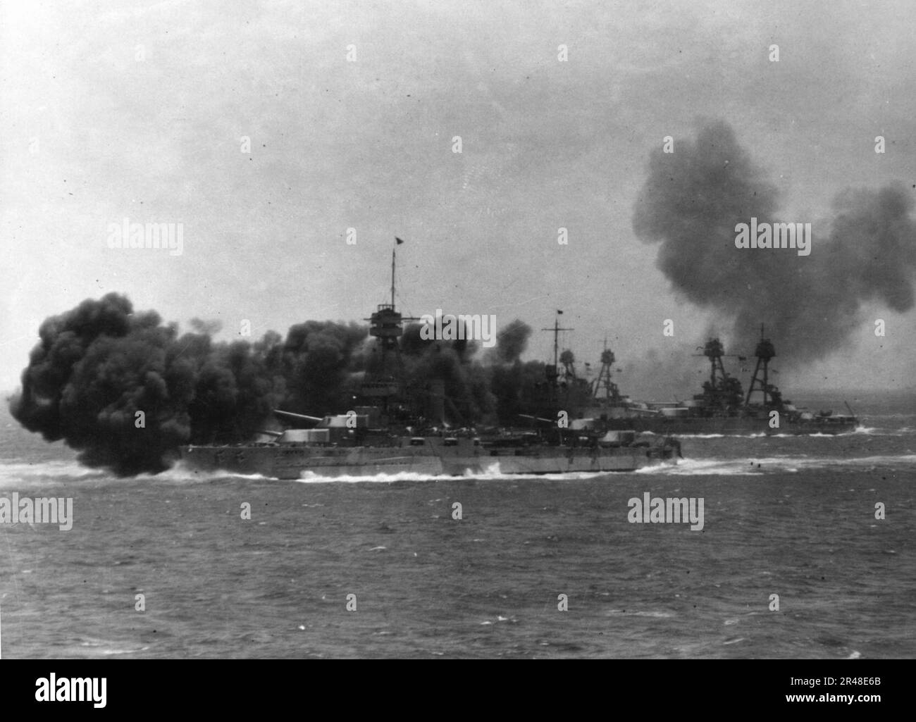 US battleships fire broadsides in the 1930s Stock Photo - Alamy