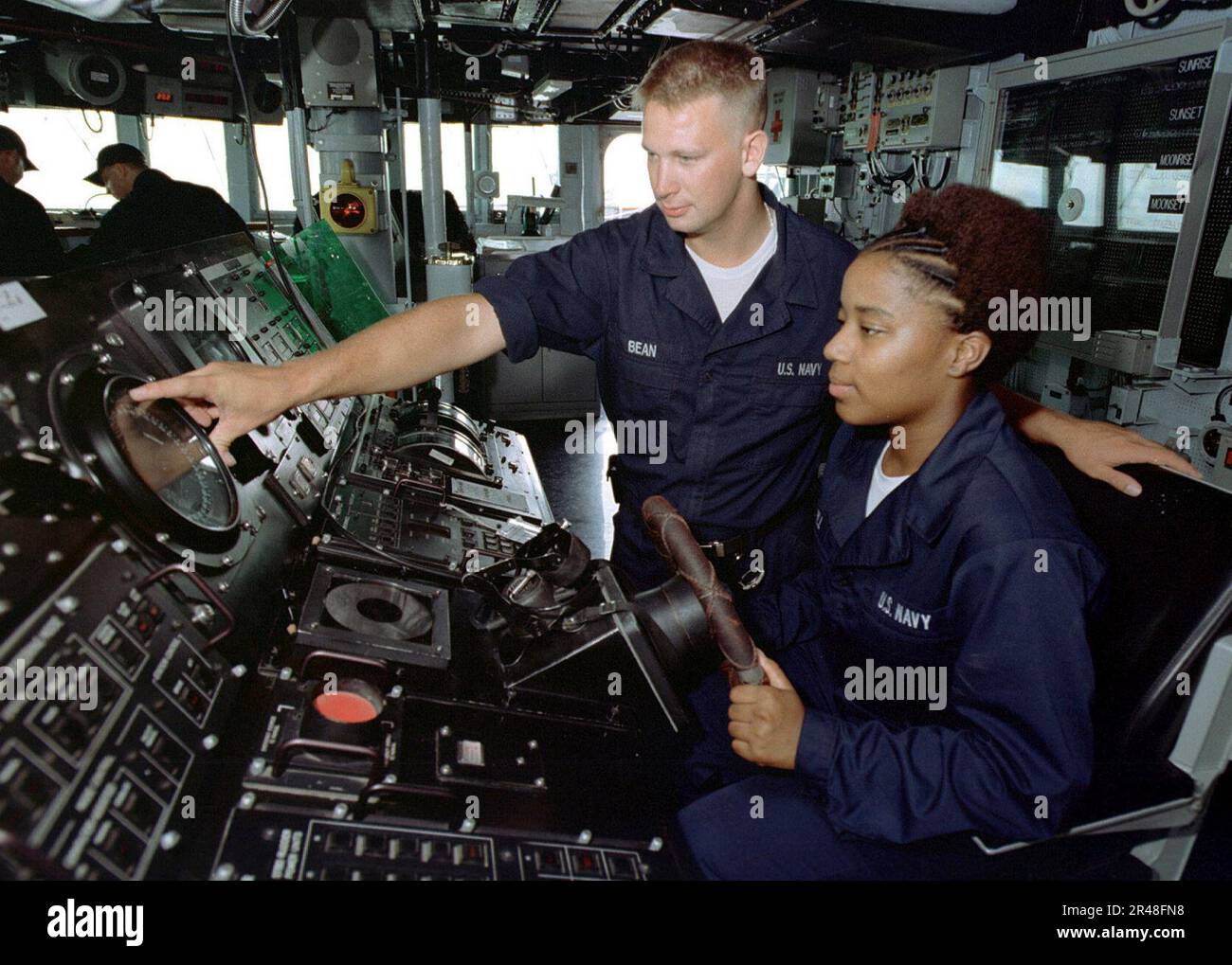 US Navy Seaman Jo, shows Midshipman 1st Class the bearing indicator on ...