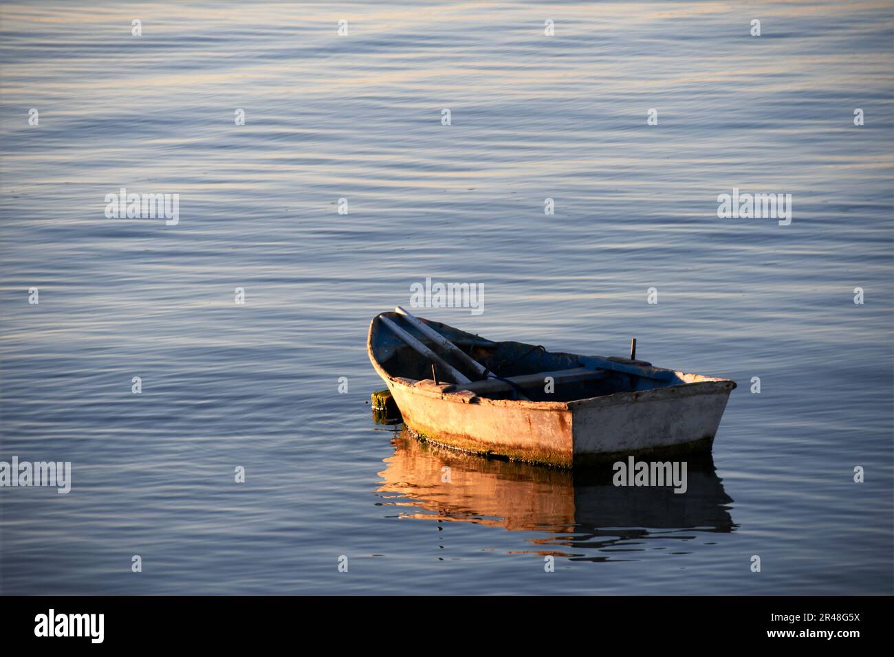 Small wooden boat for fishing anchored in the sea near the shore Stock ...