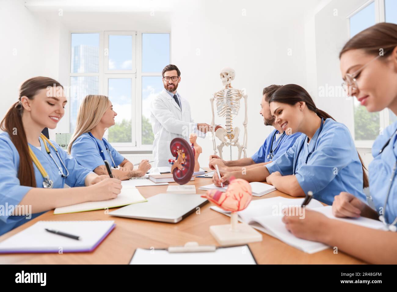 Smiling doctor giving lecture students hi-res stock photography and ...