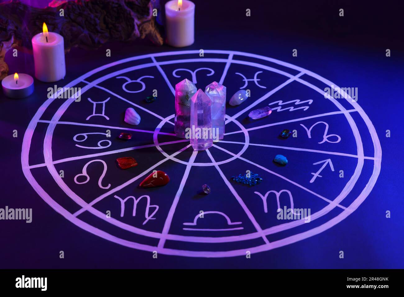 Natural stones for zodiac signs, drawn astrology chart and burning ...