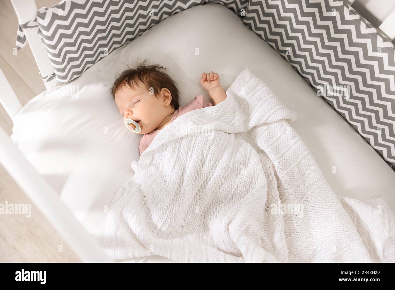 Cute little baby sleeping on cosy bed Stock Photo - Alamy