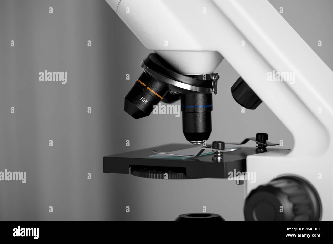 Modern microscope on grey background, closeup. Medical equipment Stock ...