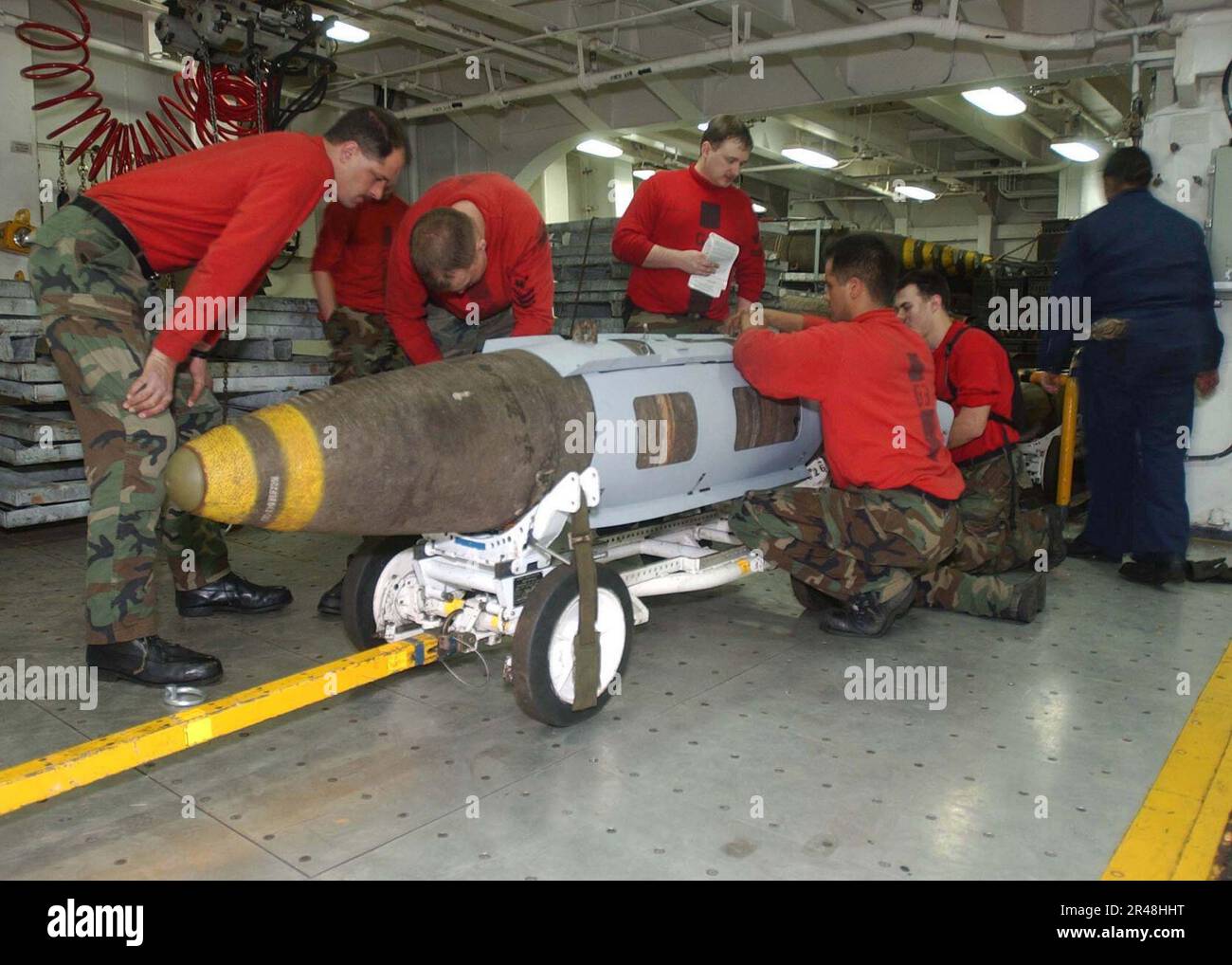US Navy Preparing JDAM weapons in the ship's magazine Stock Photo - Alamy