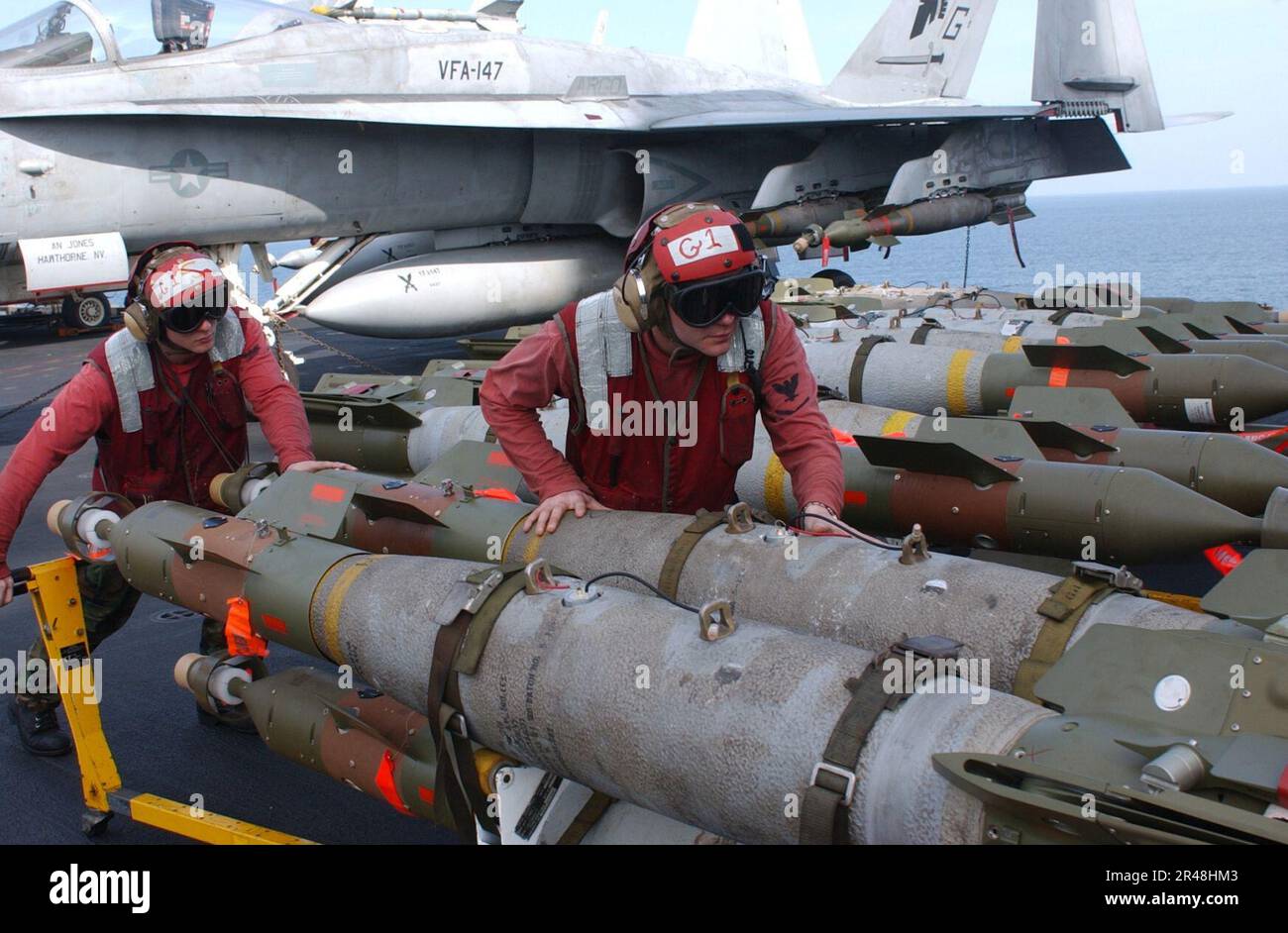 US Navy Loading bombs on aircraft aboard ship Stock Photo - Alamy
