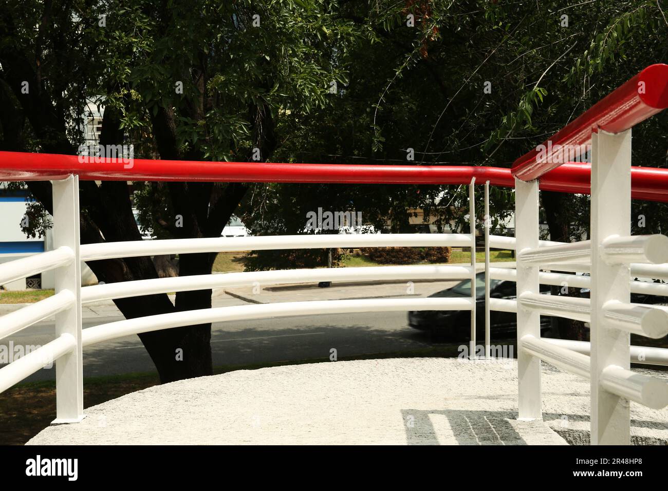 Ramp with red metal handrailings near trees outdoors Stock Photo - Alamy