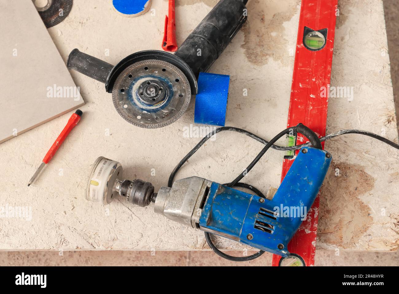 Buffing attachment drill and saw on chipboard indoors. Tiles ...