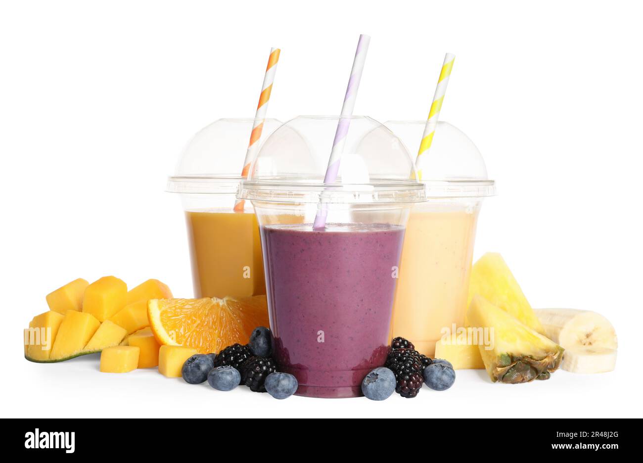Plastic cups with delicious smoothies and ingredients on white ...