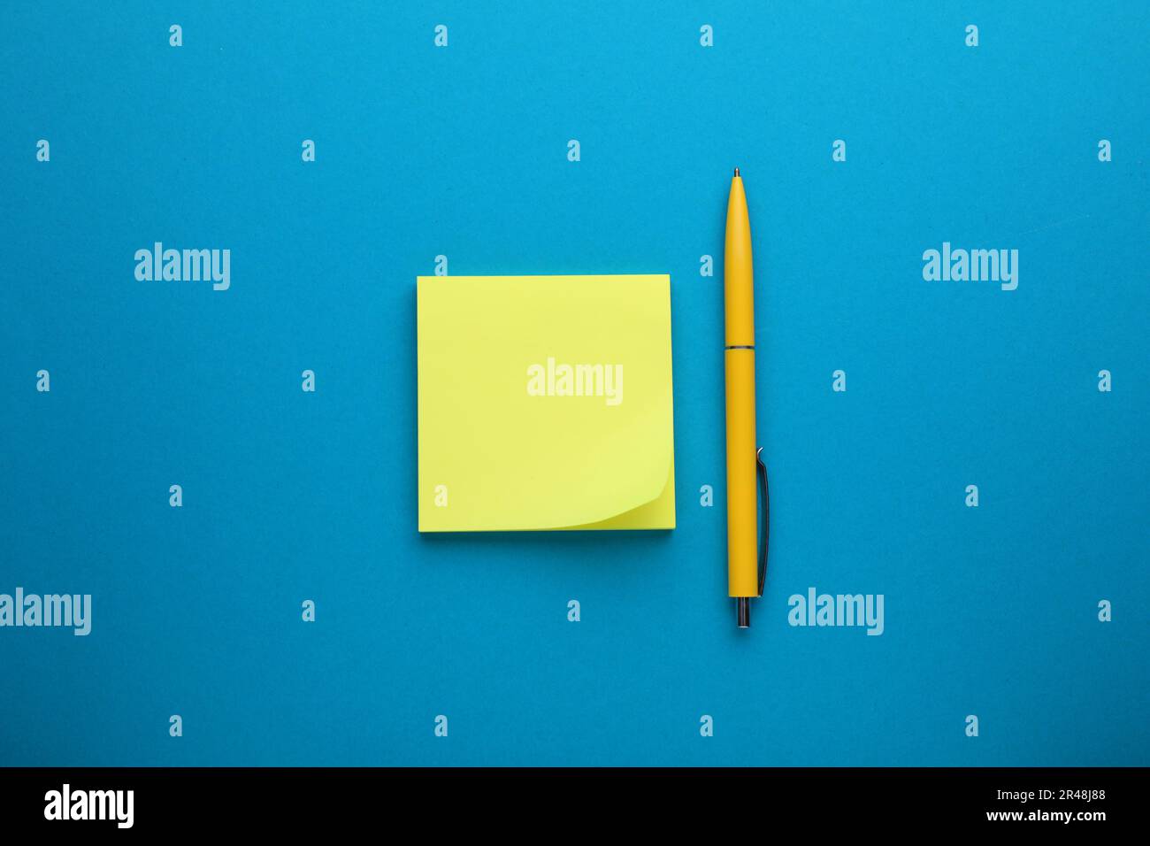 Paper note and pen on blue background, top view Stock Photo - Alamy