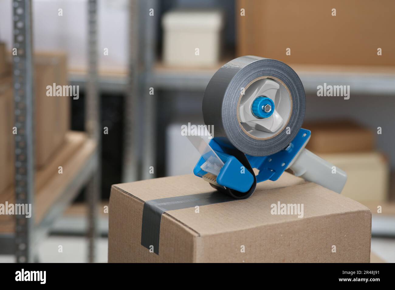 Taping box with adhesive tape dispenser indoors. Space for text Stock ...