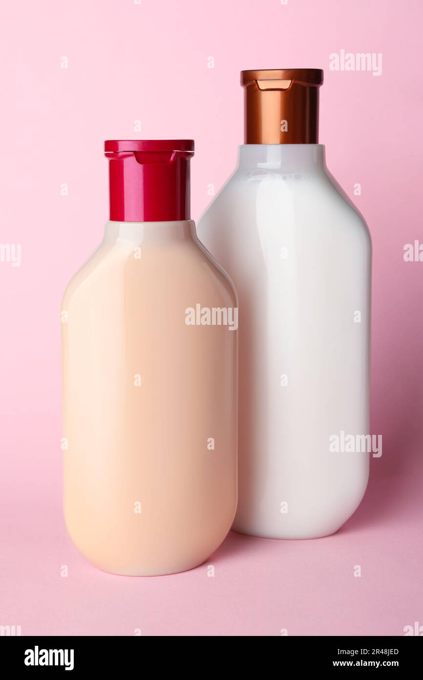 Bottles of shampoo on pale pink background Stock Photo - Alamy