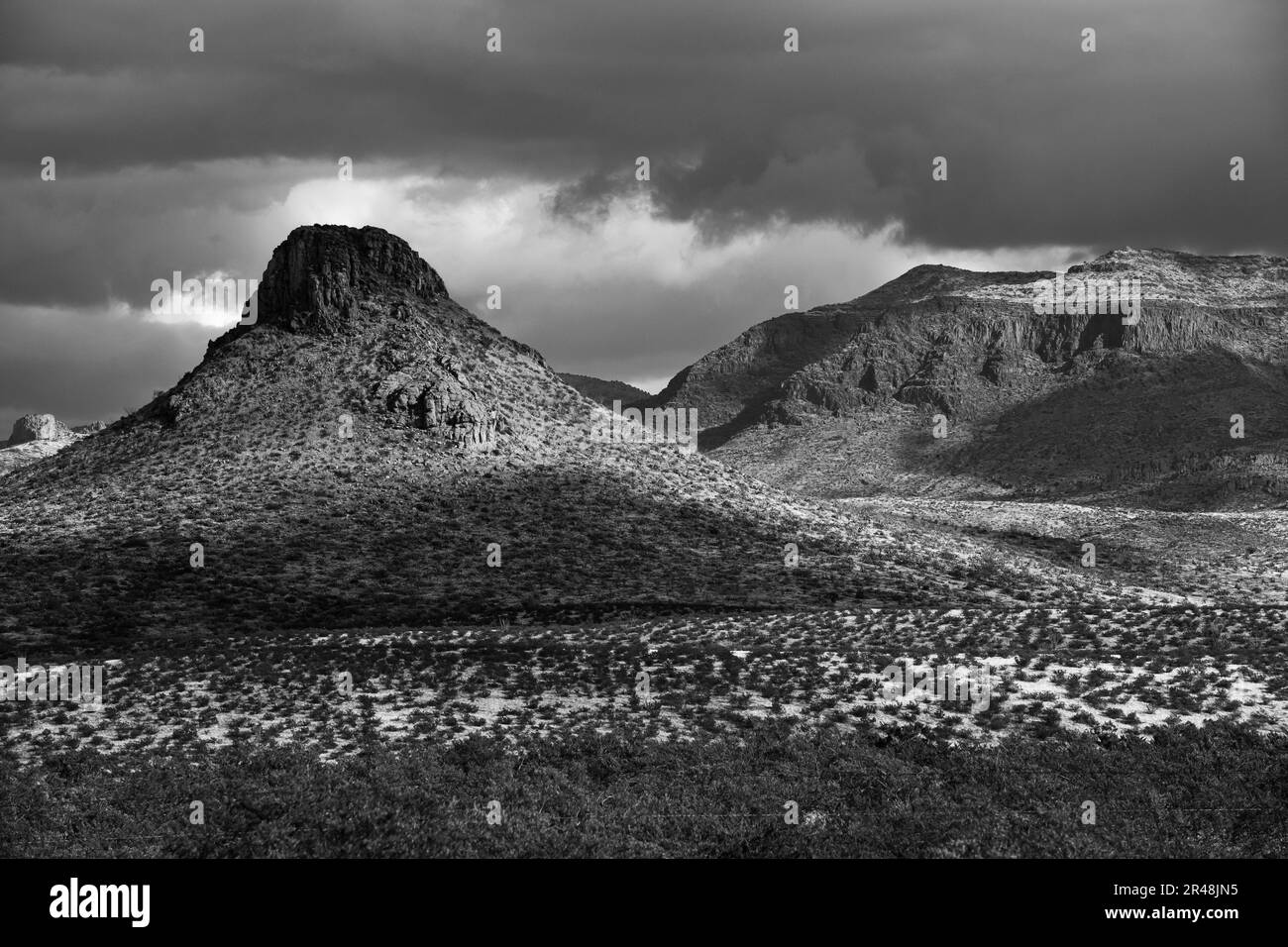 A stunning monochrome landscape of tall mountain peaks in a remote ...