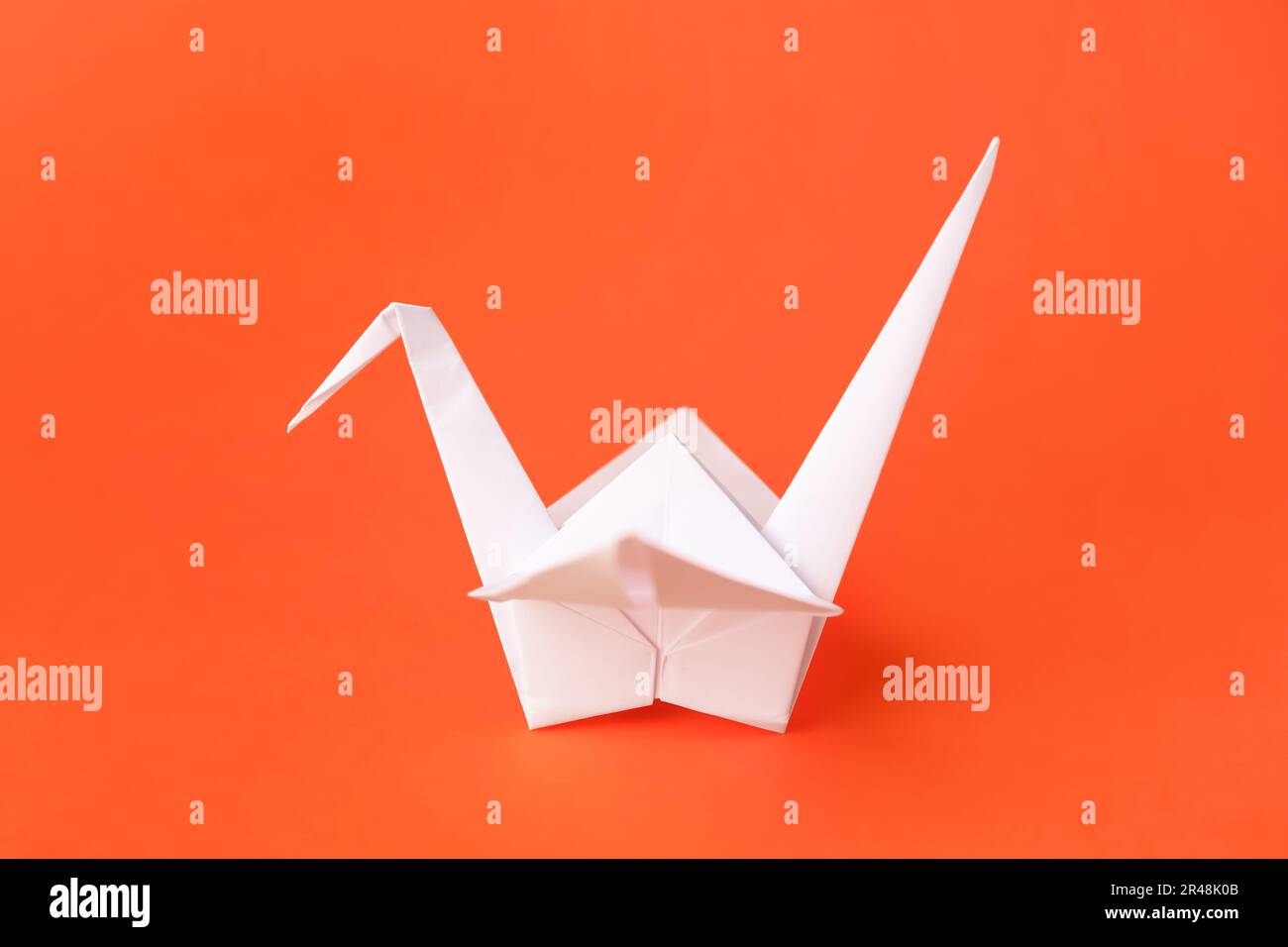 Origami art. Handmade paper crane on orange background, closeup Stock ...