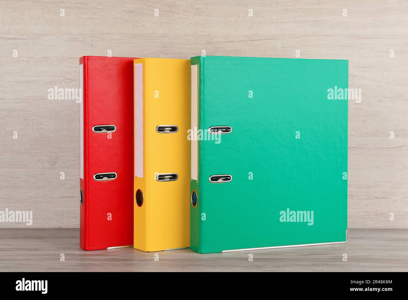 Bright hardcover office folders on white wooden table Stock Photo - Alamy