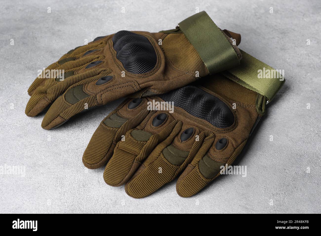 Tactical gloves on light gray background. Military training equipment ...
