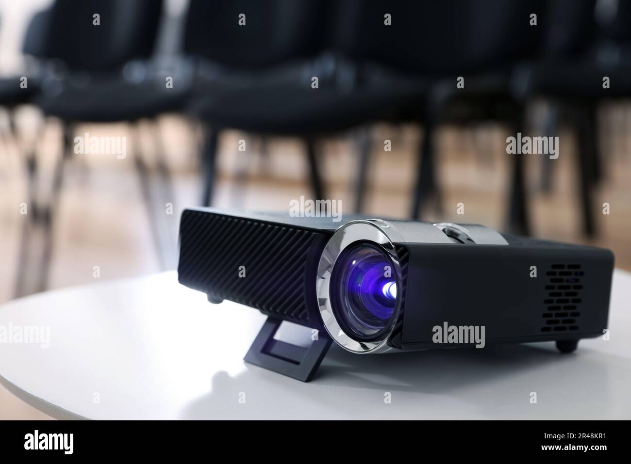 Modern video projector on table in conference room Stock Photo - Alamy