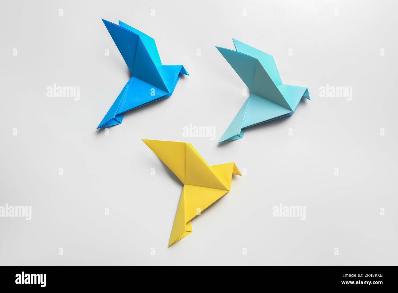 Beautiful colorful origami birds on white background, flat lay Stock ...