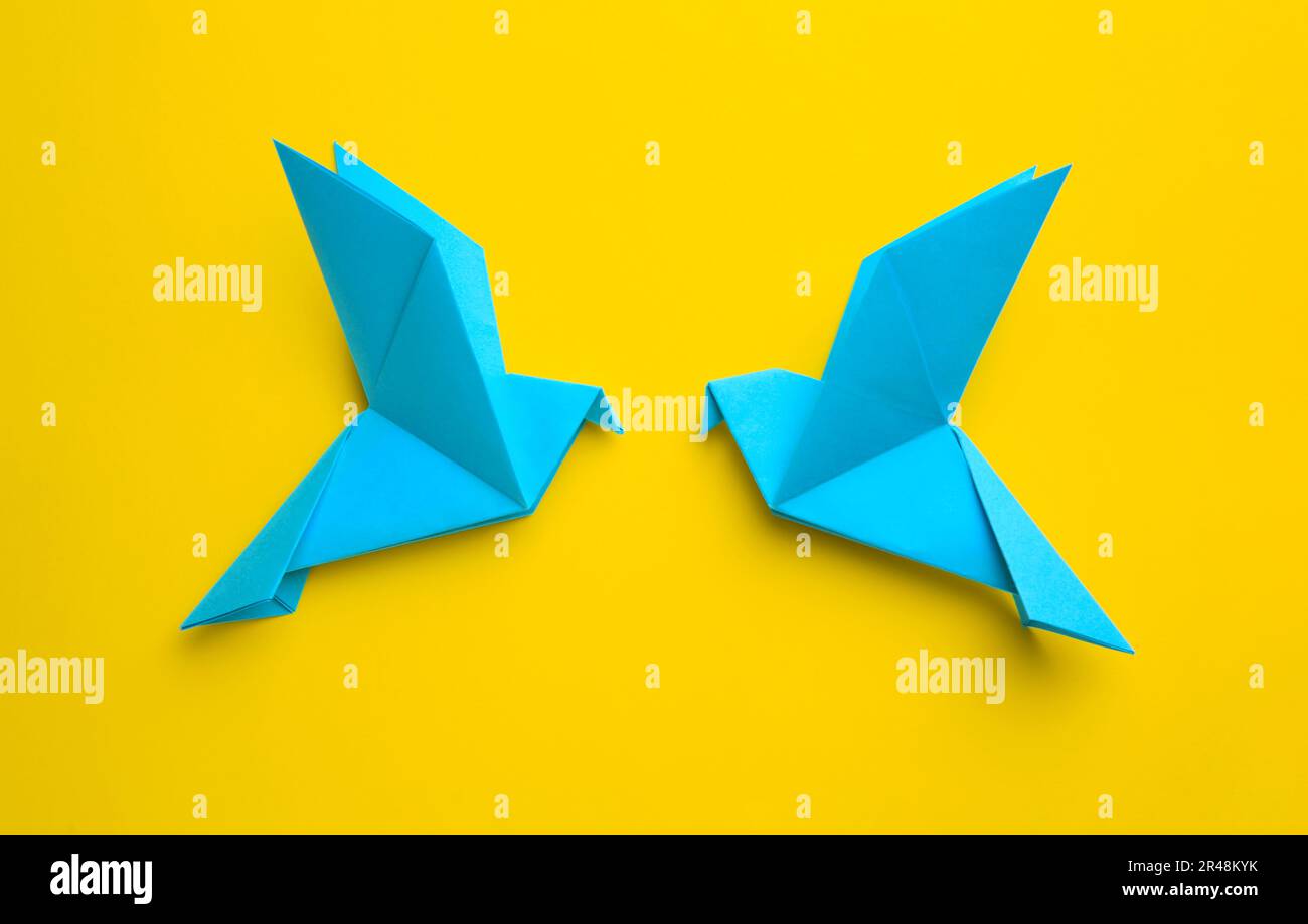 Origami art. Colorful handmade paper birds on yellow background, flat ...