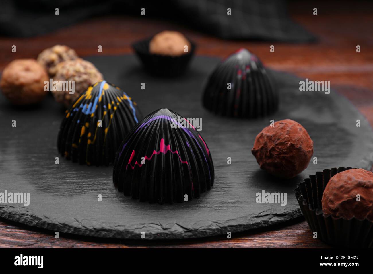 Different tasty chocolate candies on slate plate Stock Photo - Alamy
