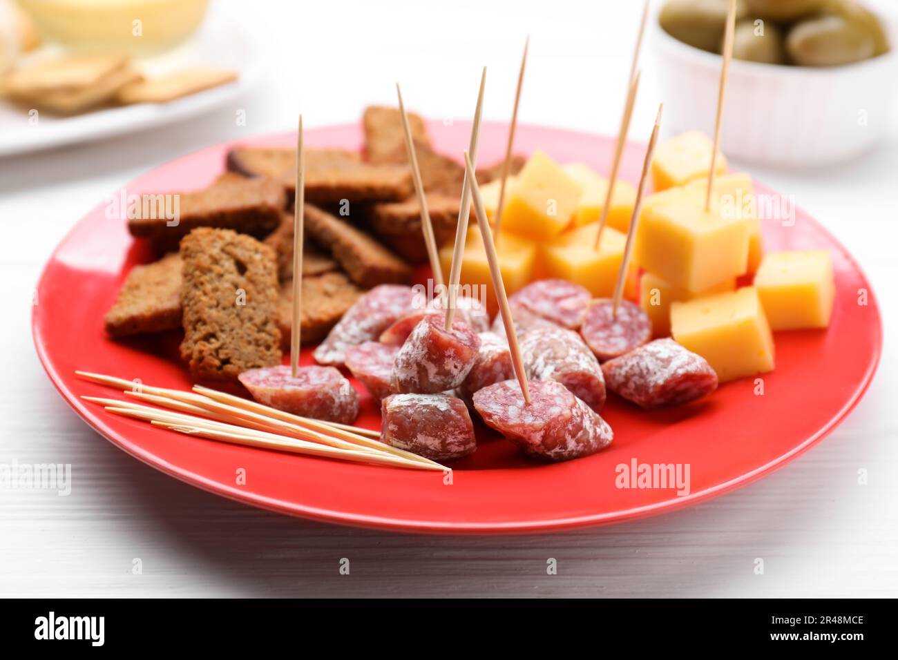 Toothpick appetizers. Pieces of sausage, cheese and croutons on white ...