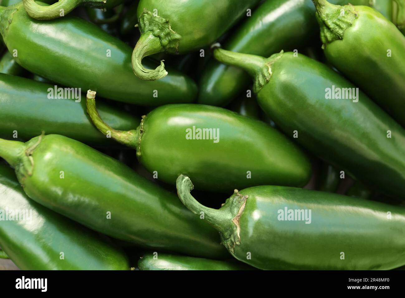 Green hot chili peppers as background, closeup Stock Photo - Alamy