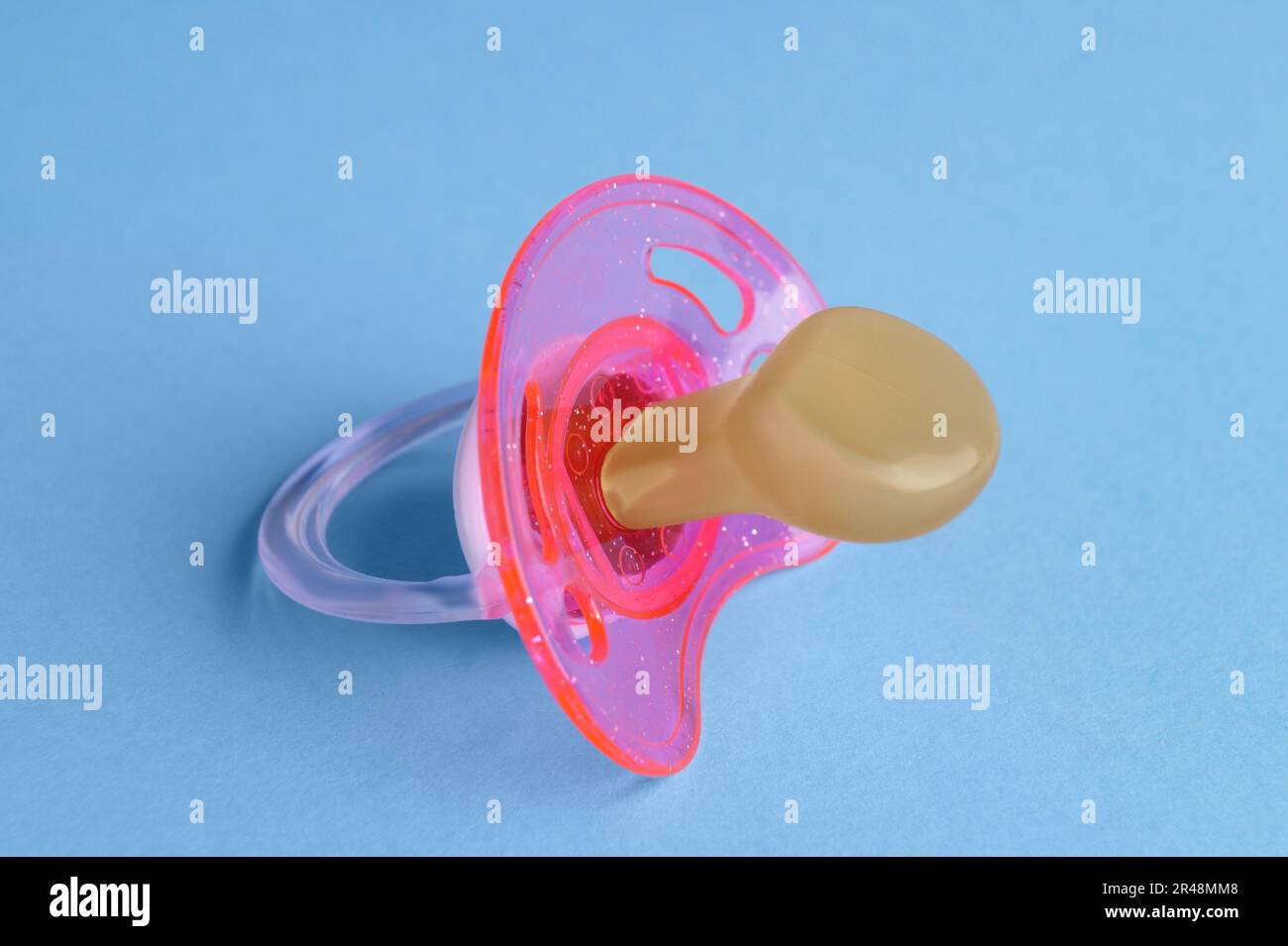 New baby pacifier on light blue background, closeup Stock Photo - Alamy