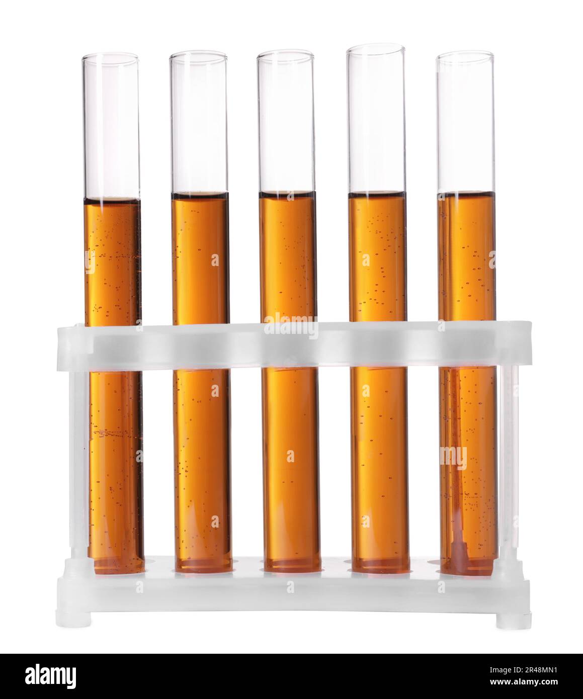 Test tubes with brown liquid in stand on white background Stock Photo ...