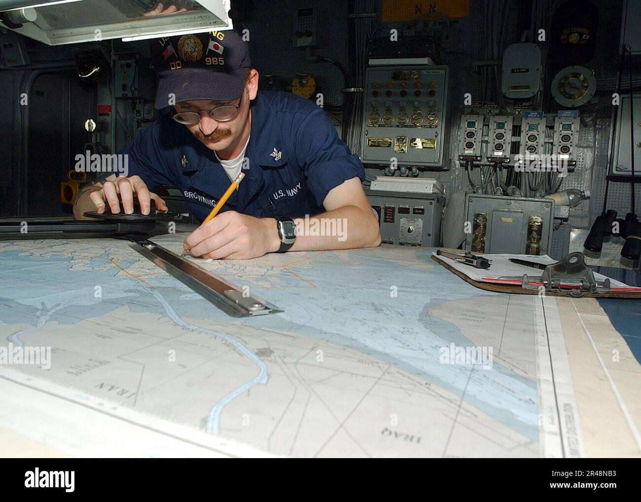 US Navy Quartermaster plots ship's position on the bridge Stock Photo ...