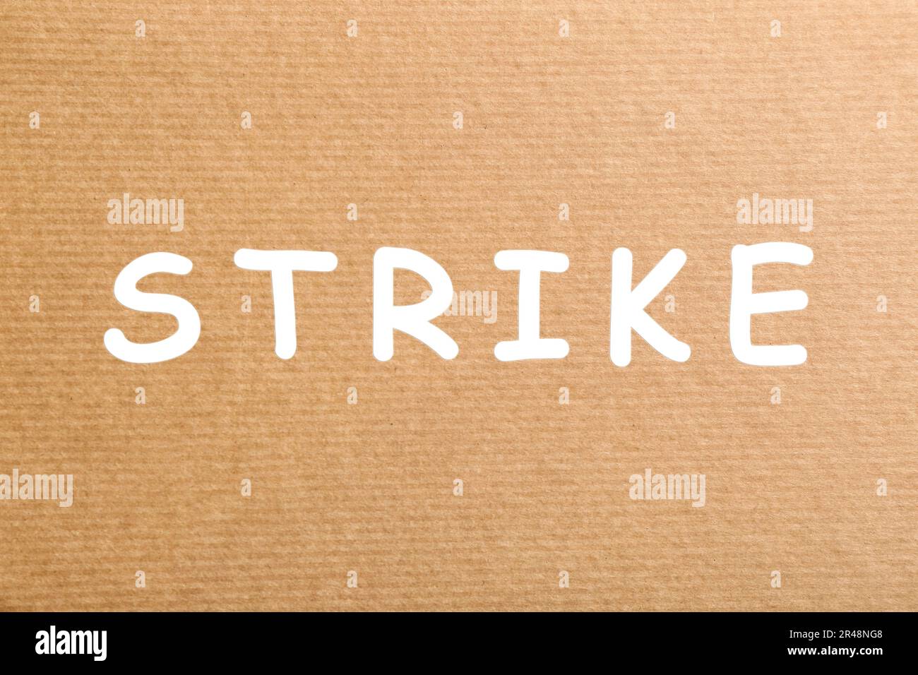 Protest concept. Word Strike on kraft paper Stock Photo - Alamy