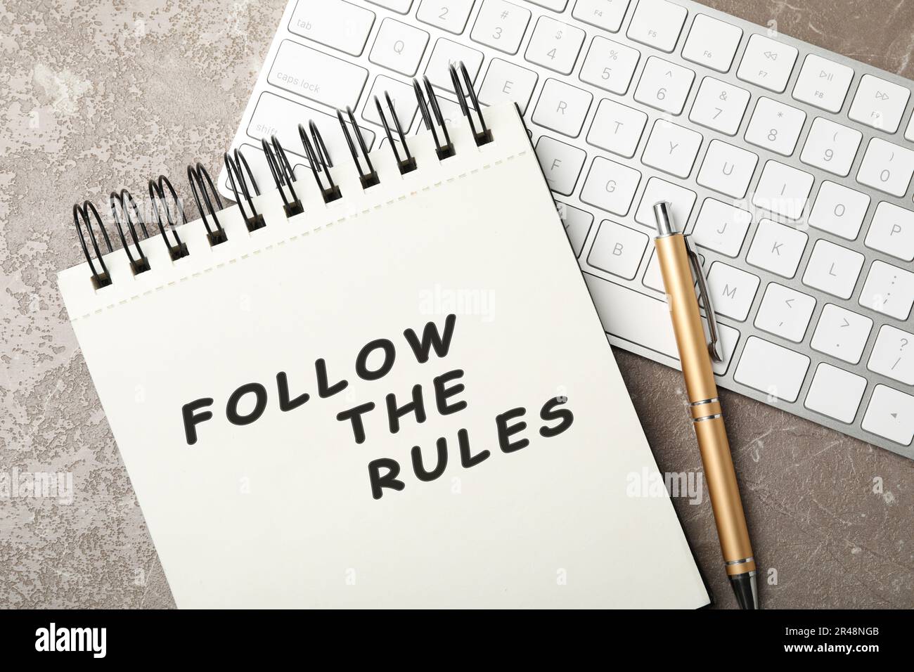 Notebook with phrase Follow The Rules, pen and computer keyboard on ...
