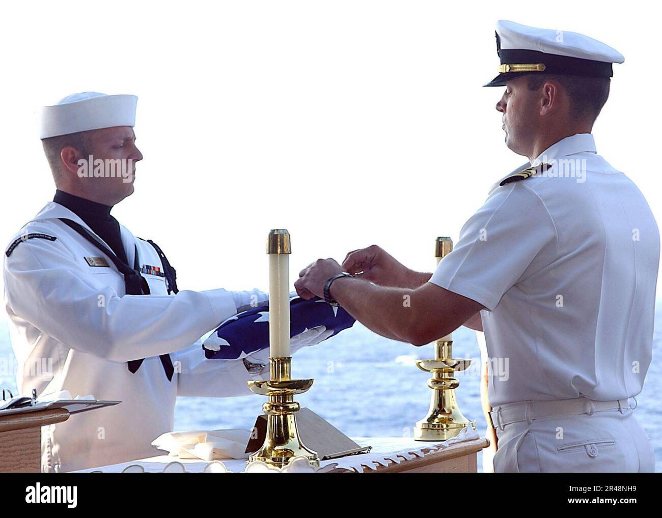 US Navy Sailors participate in a burial-at-sea held aboard USS George ...