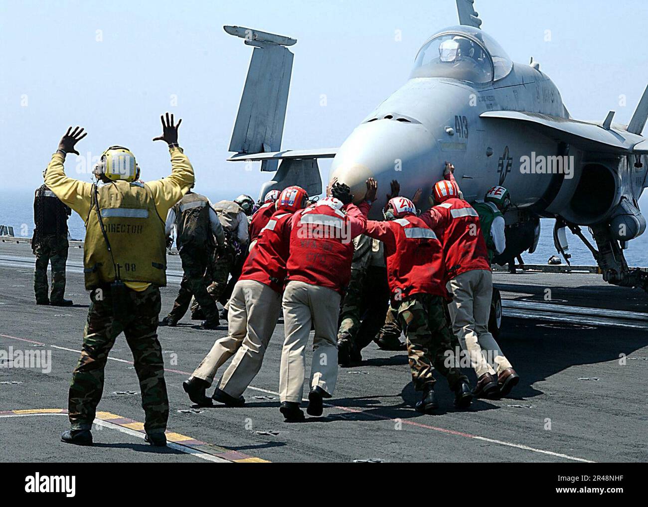 US Navy Sailors ''push back'' an F-A-18 ''Hornet'' strike fighter ...