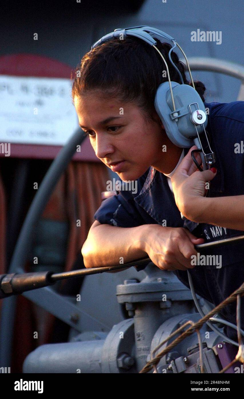 US Navy Sailor aboard USS Hopper provides communications with small ...