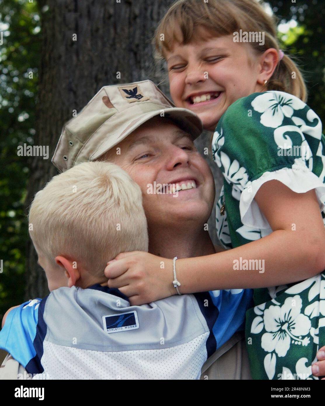US Navy Utilitiesman 1st Class gets a big hug from his children at the ...