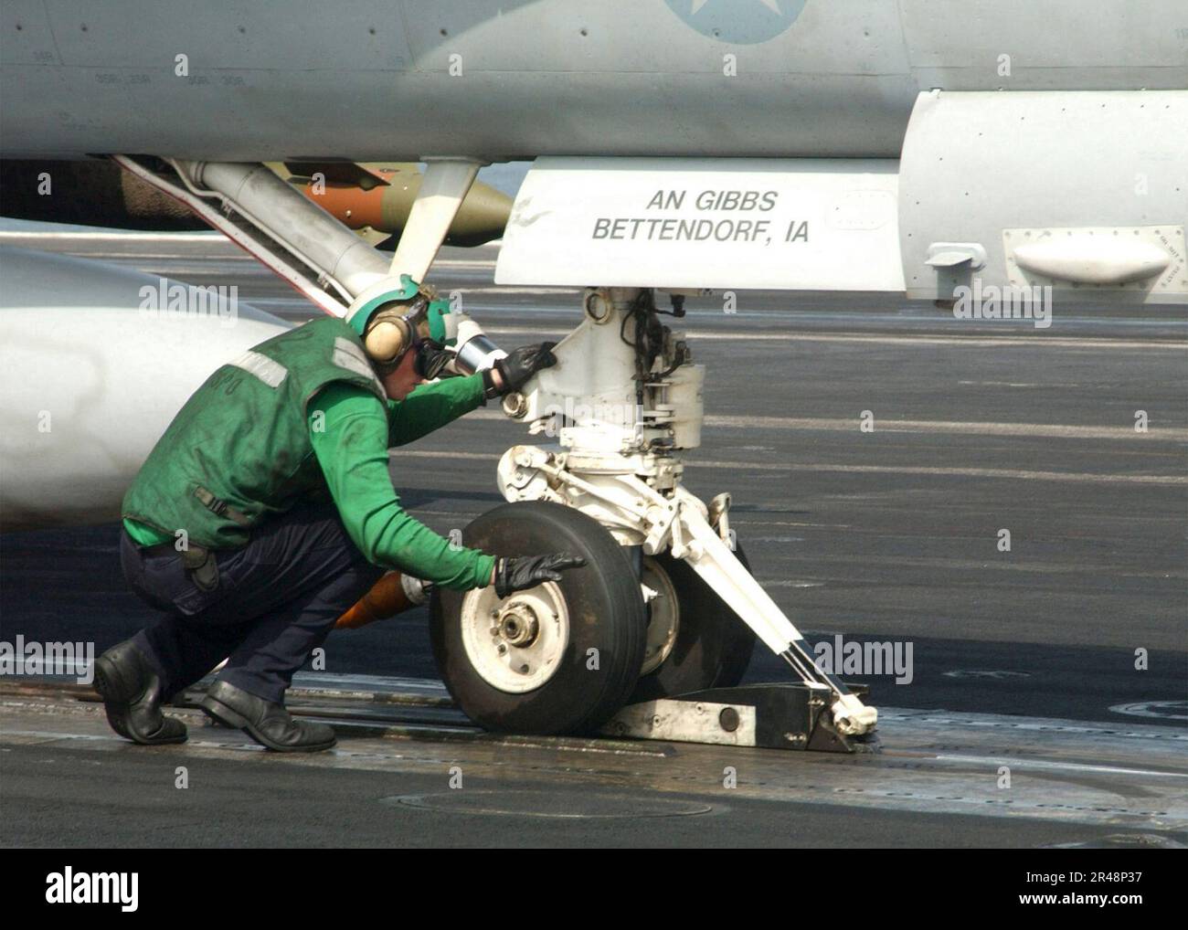 US Navy Sailor prepars and aircraft for catapult launch aboard CVN 73 ...