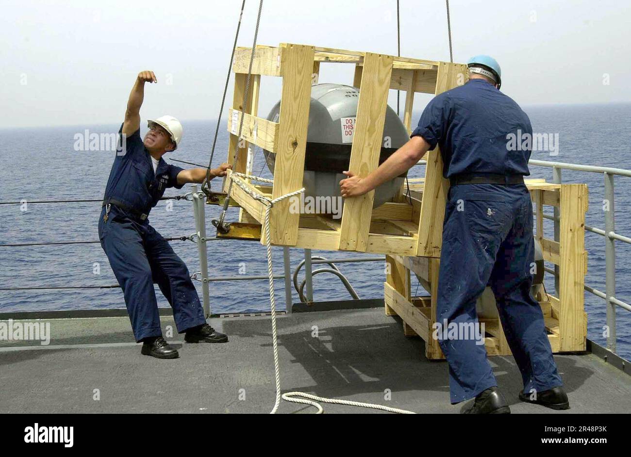 US Navy A Boatswain's Mate aboard USS La Salle directs the Crane ...