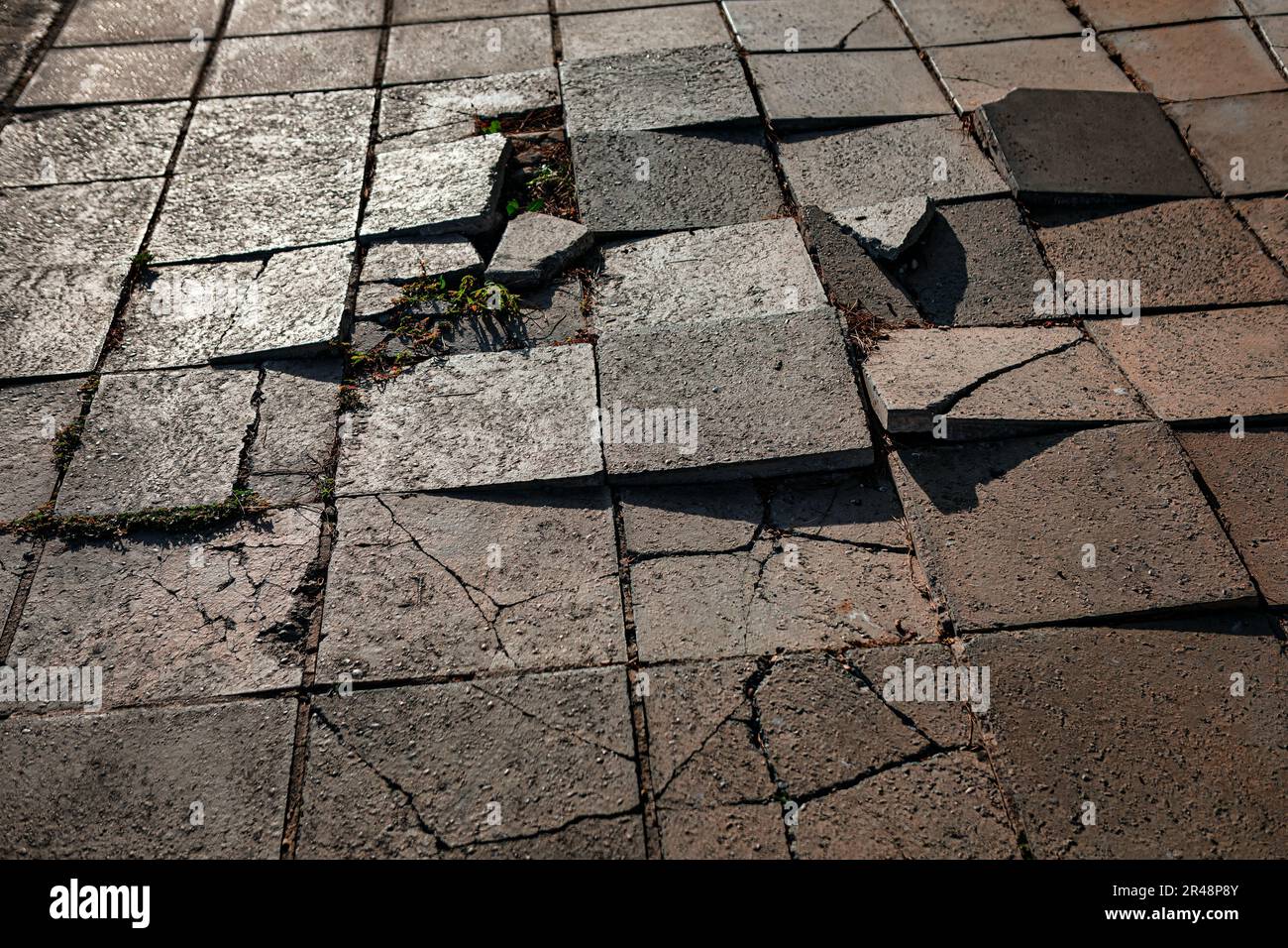 Shattered pavement . Broken cobblestones on the street Stock Photo - Alamy