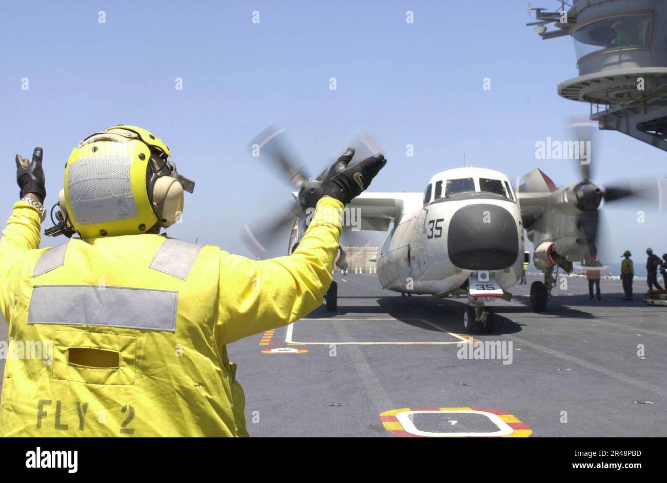 US Navy C-2 Greyhound receives instructions from flight deck director ...