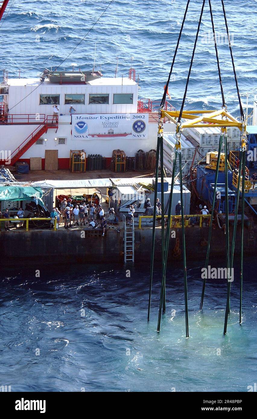 US Navy Salvage crews hoist the gun turret of the Civil War ironclad ...