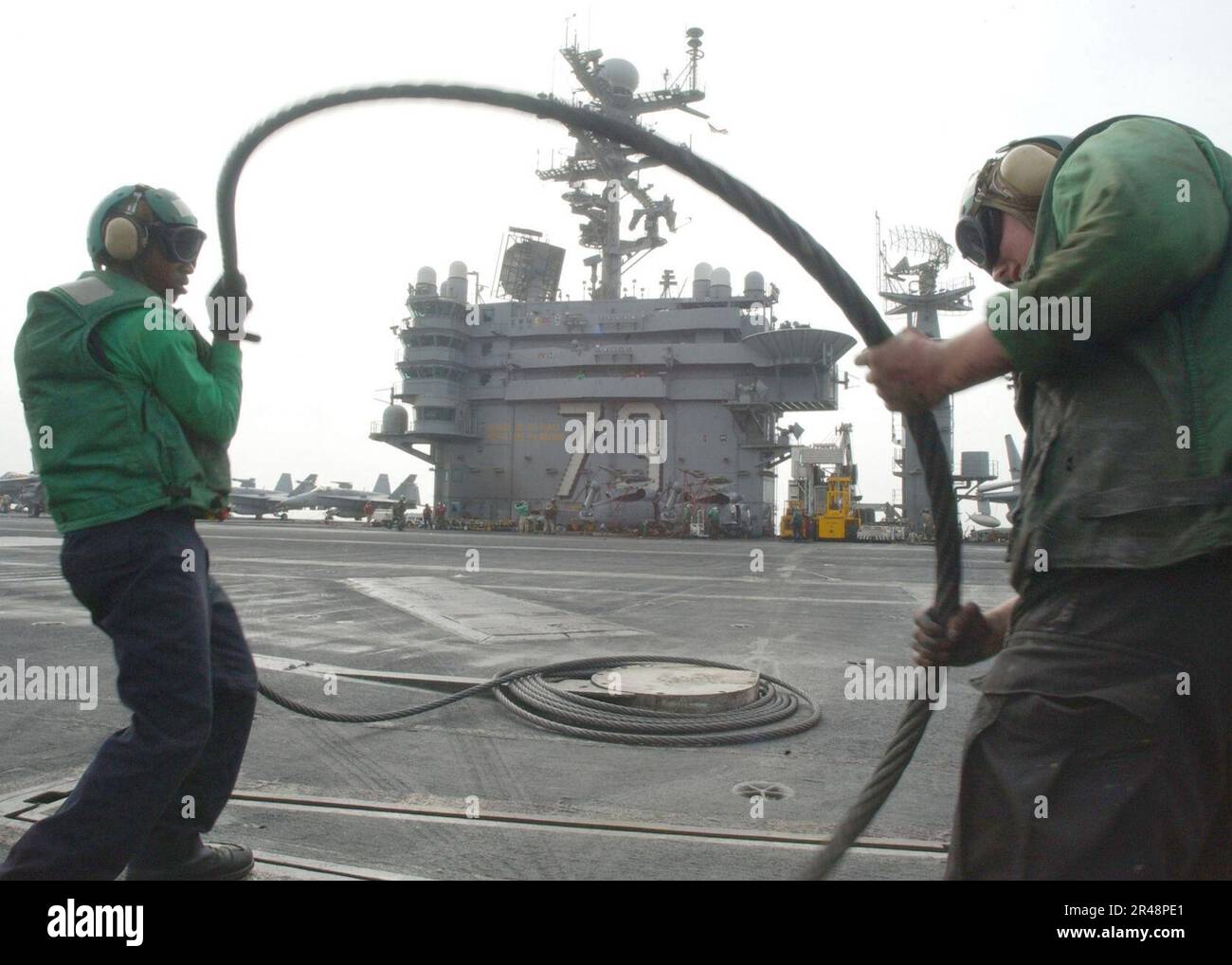 US Navy Flight Deck personnel replace arresting gear wire Stock Photo ...