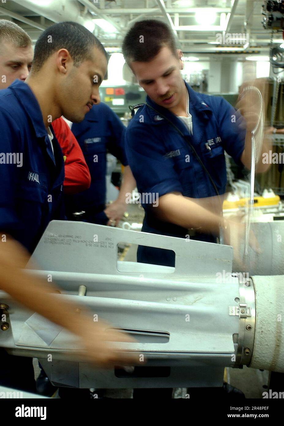 US Navy Sailors aboard CVN 73 dismantal a MK-82 bomb in one of the ship ...
