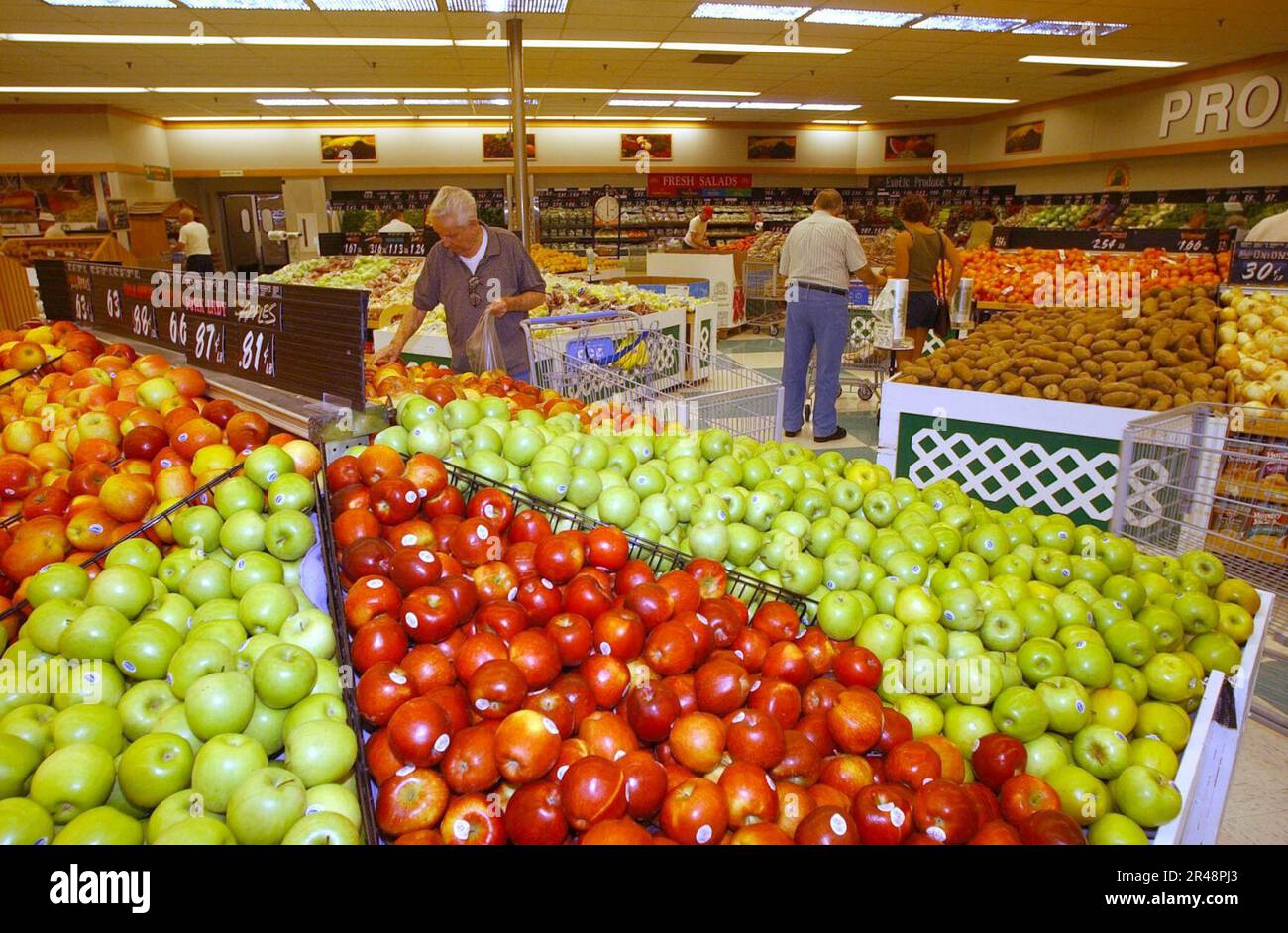 US Navy Navy customers look for ripe apples at the commissary located ...