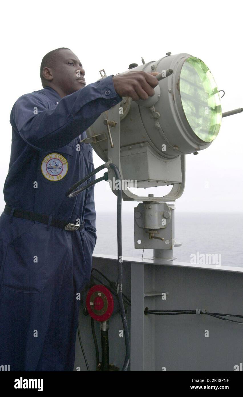 US Navy Signalman flashes signals during vertrep Stock Photo - Alamy