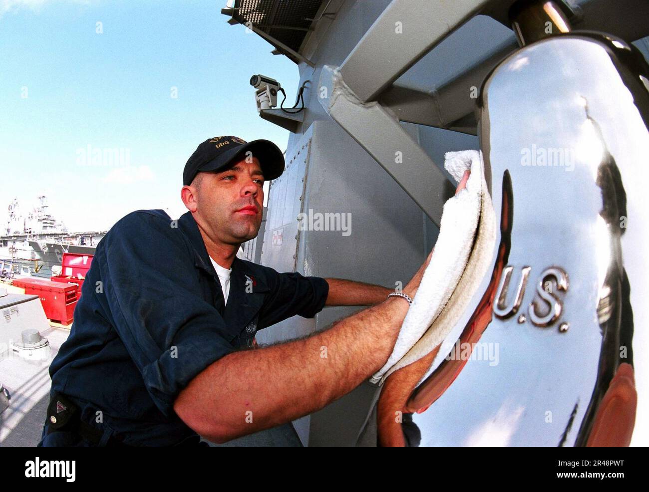 US Navy Sailor polishes ship's bell Stock Photo - Alamy